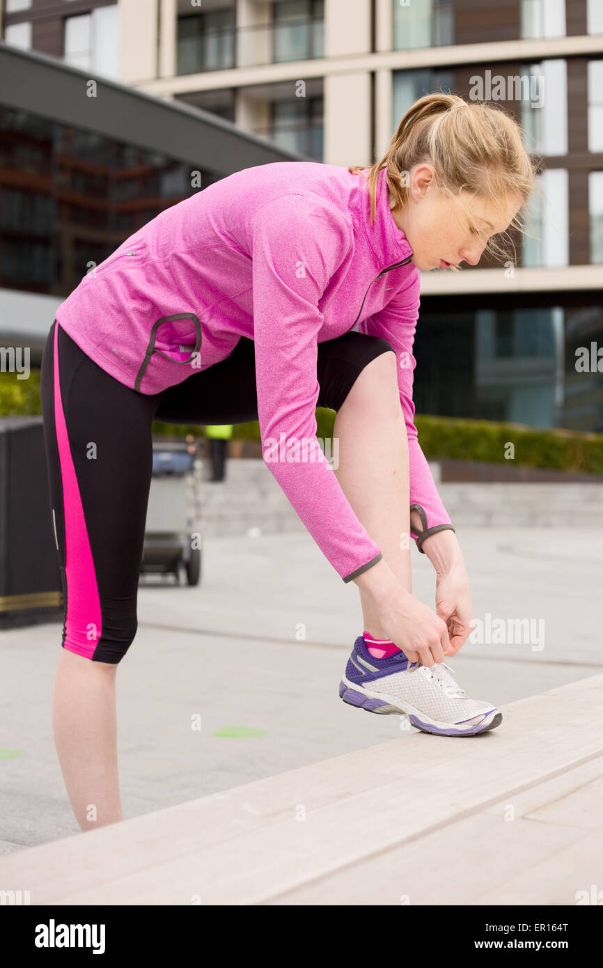 Lady tying shoe lace running hi-res stock photography and images - Alamy