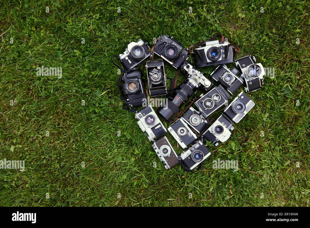 Heart shape made by collection of old retro film cameras, lying on ...