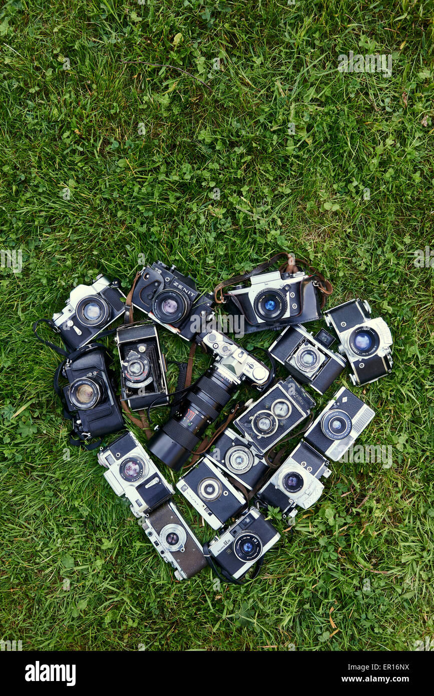 Heart shape made by collection of old retro film cameras, lying on ...