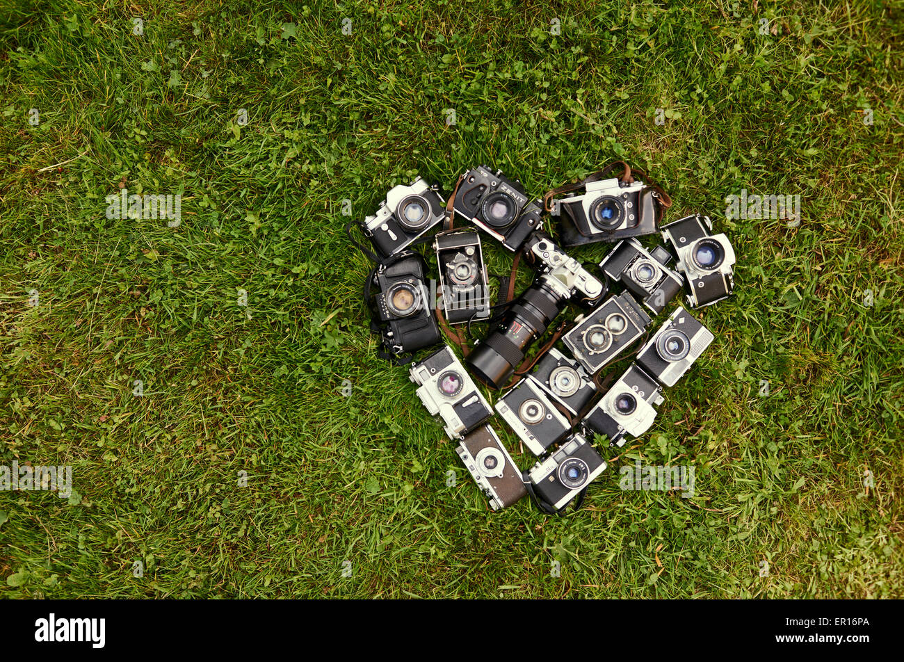 Heart shape made by collection of old retro film cameras, lying on ...
