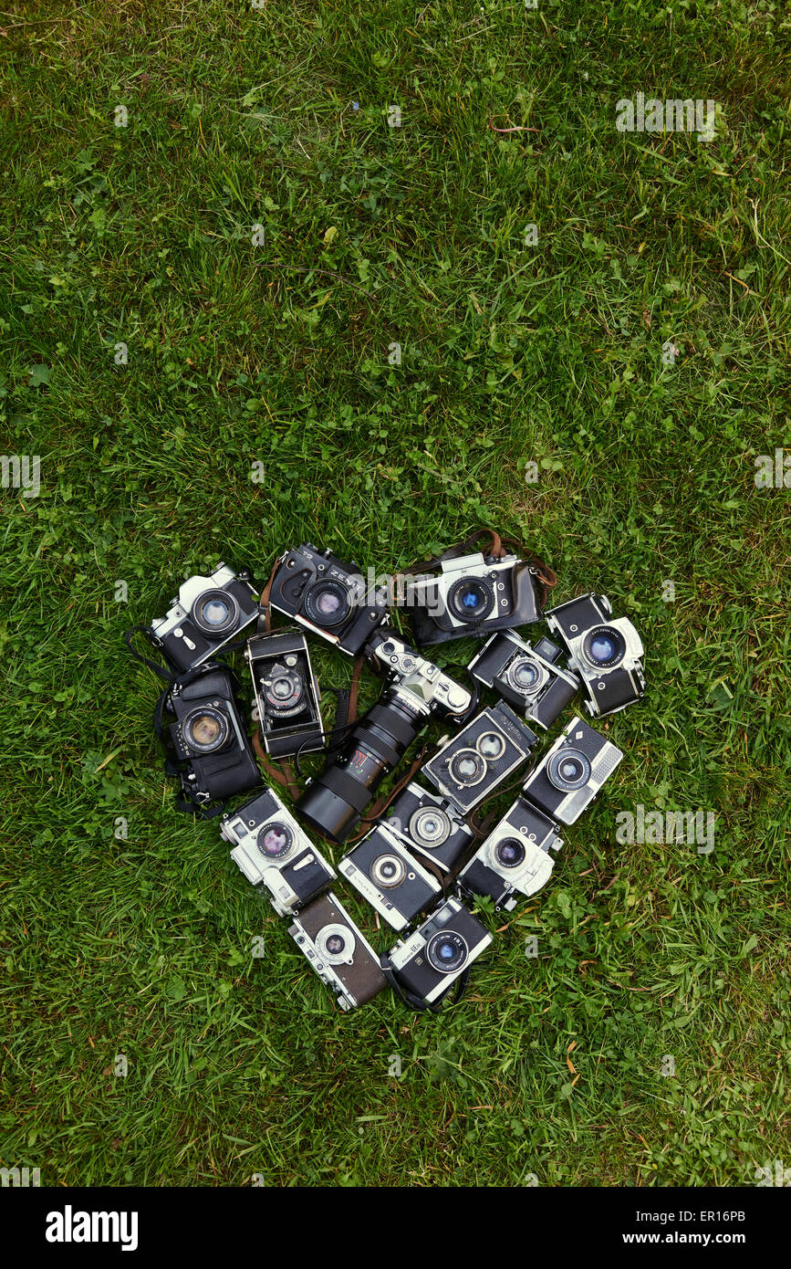 Heart shape made by collection of old retro film cameras, lying on ...