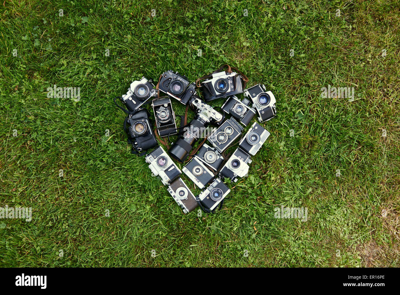Heart shape made by collection of old retro film cameras, lying on ...
