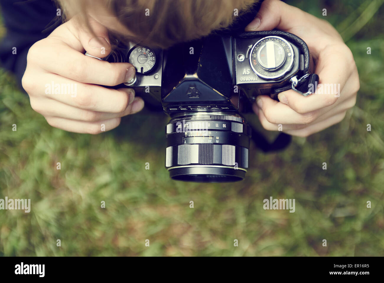 Child blond boy with Vintage photo film camera photographing outside ...