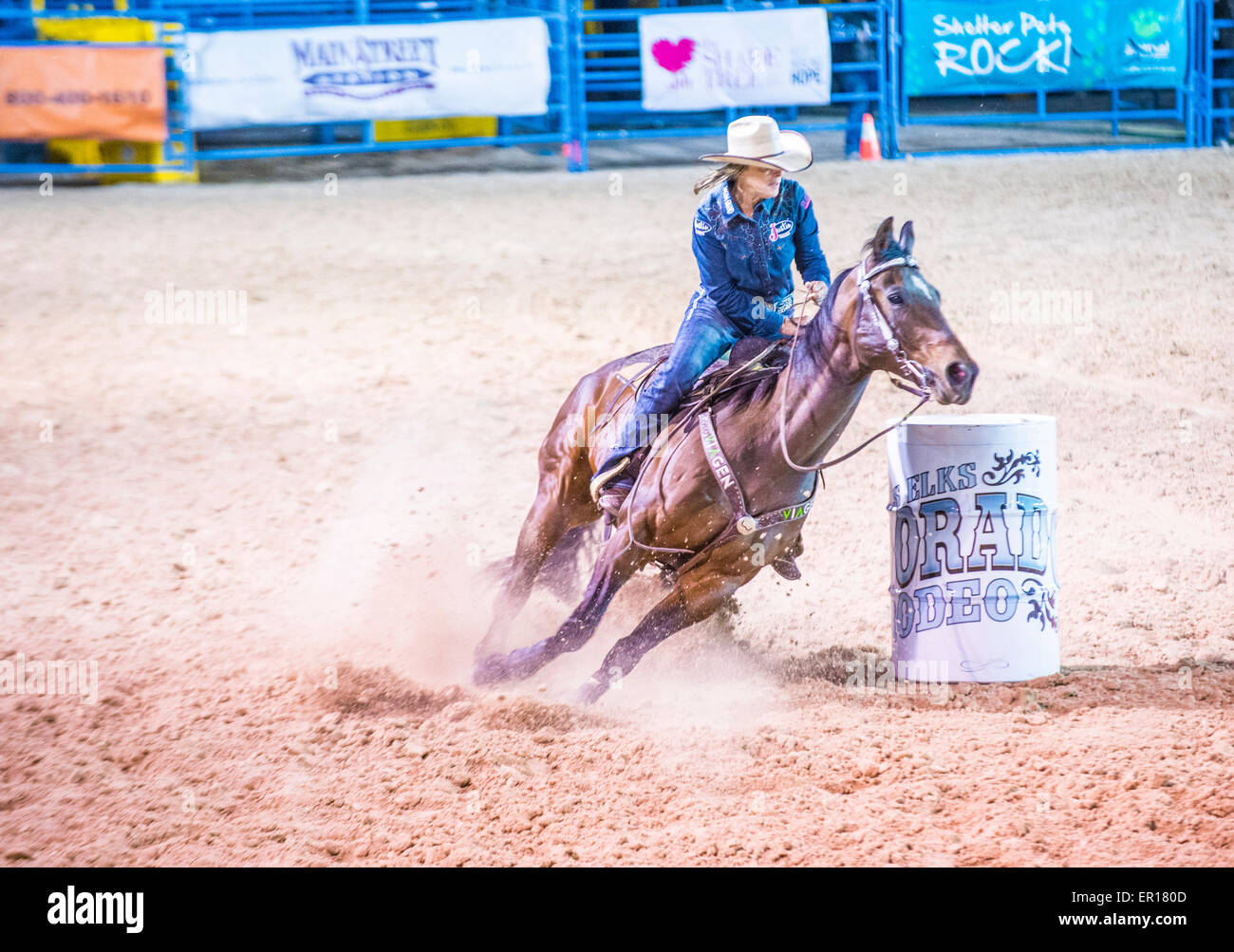 Cowgirl Participating in a Barrel racing competition at the Helldorado ...