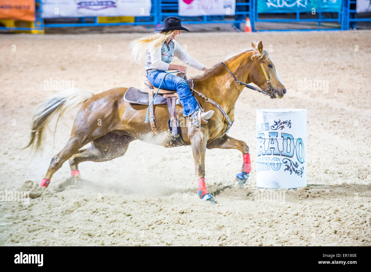 Cowgirl Participating in a Barrel racing competition at the Helldorado ...