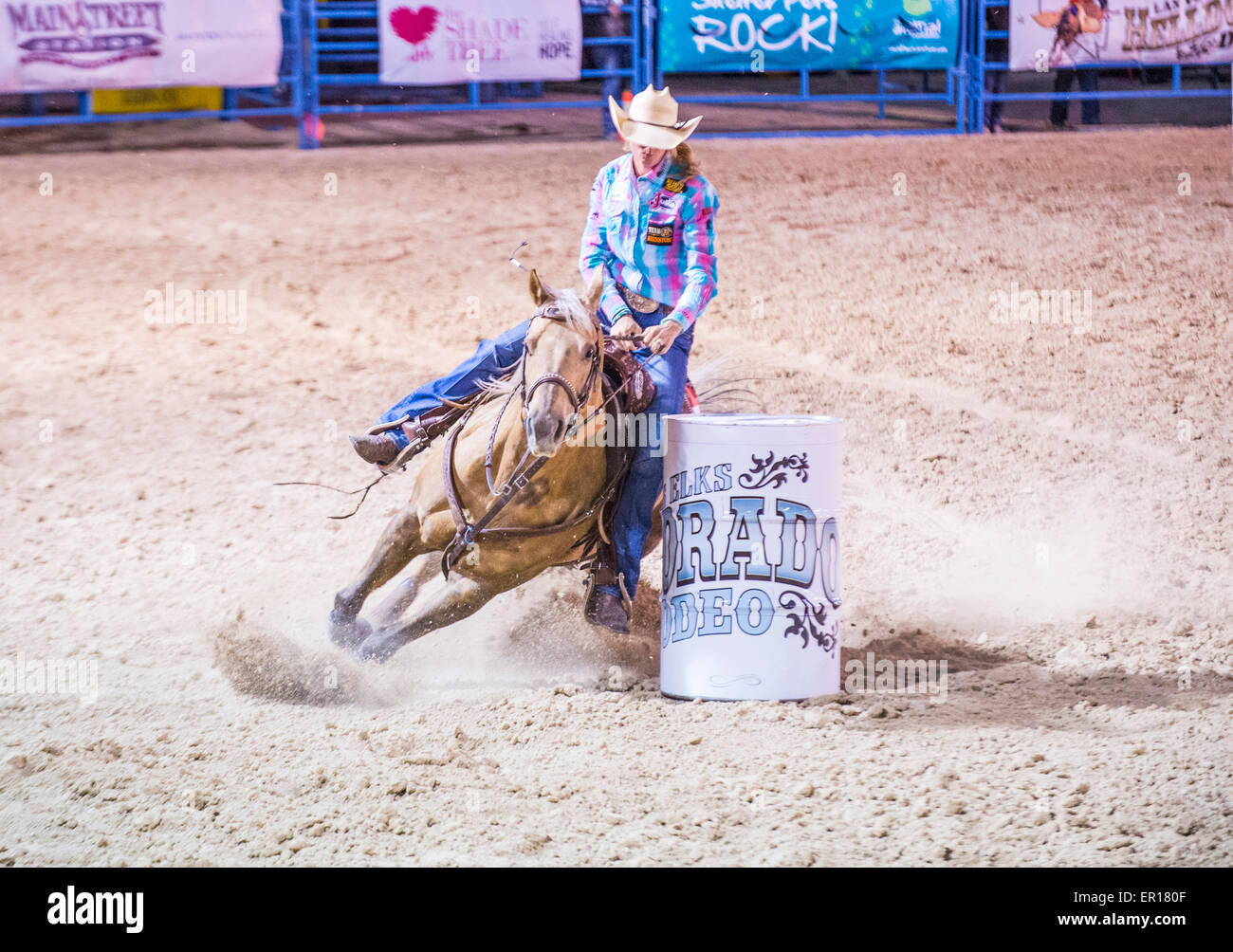 Cowgirl Participating in a Barrel racing competition at the Helldorado ...