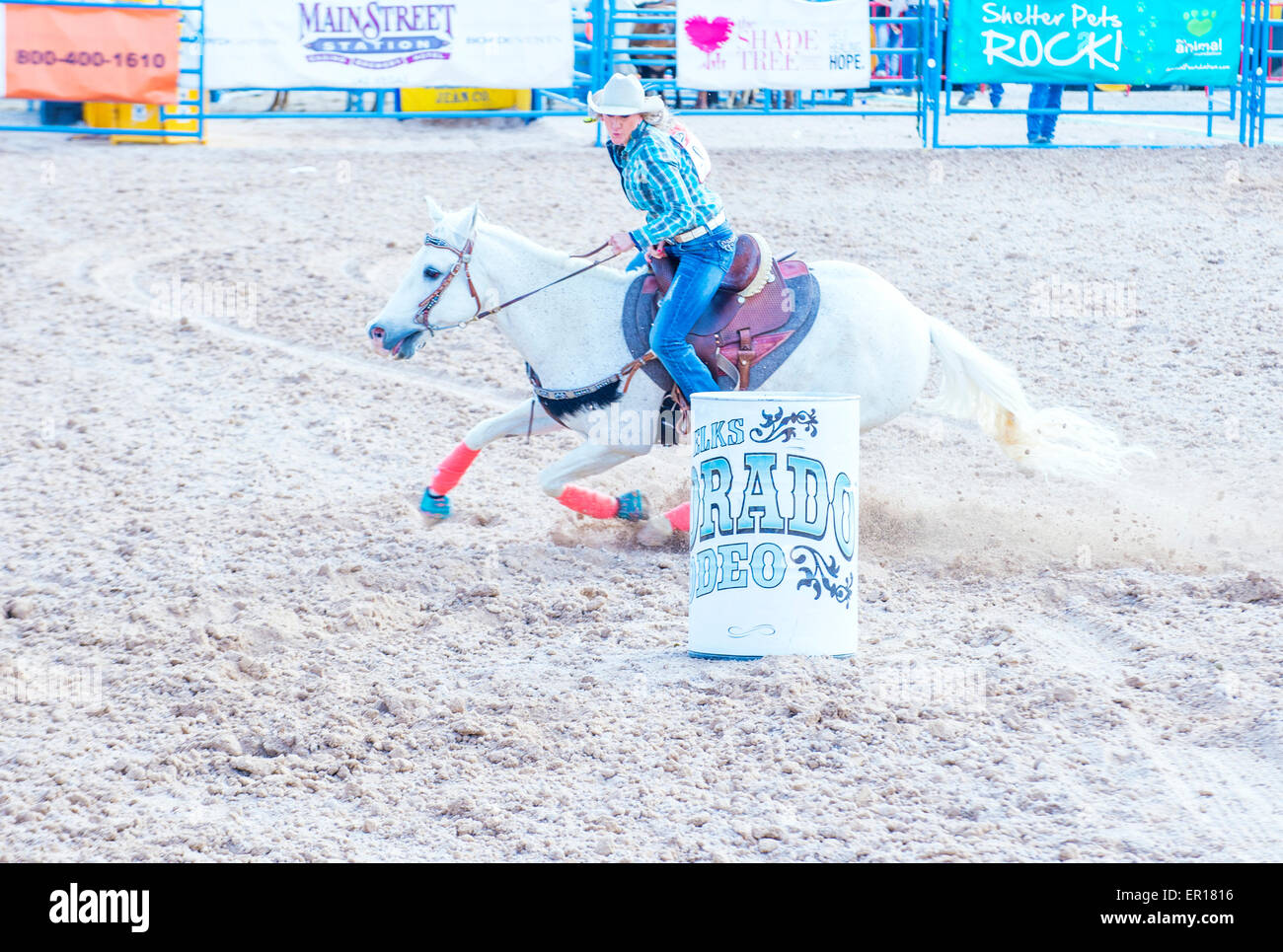 Cowgirl Participating in a Barrel racing competition at the Helldorado ...