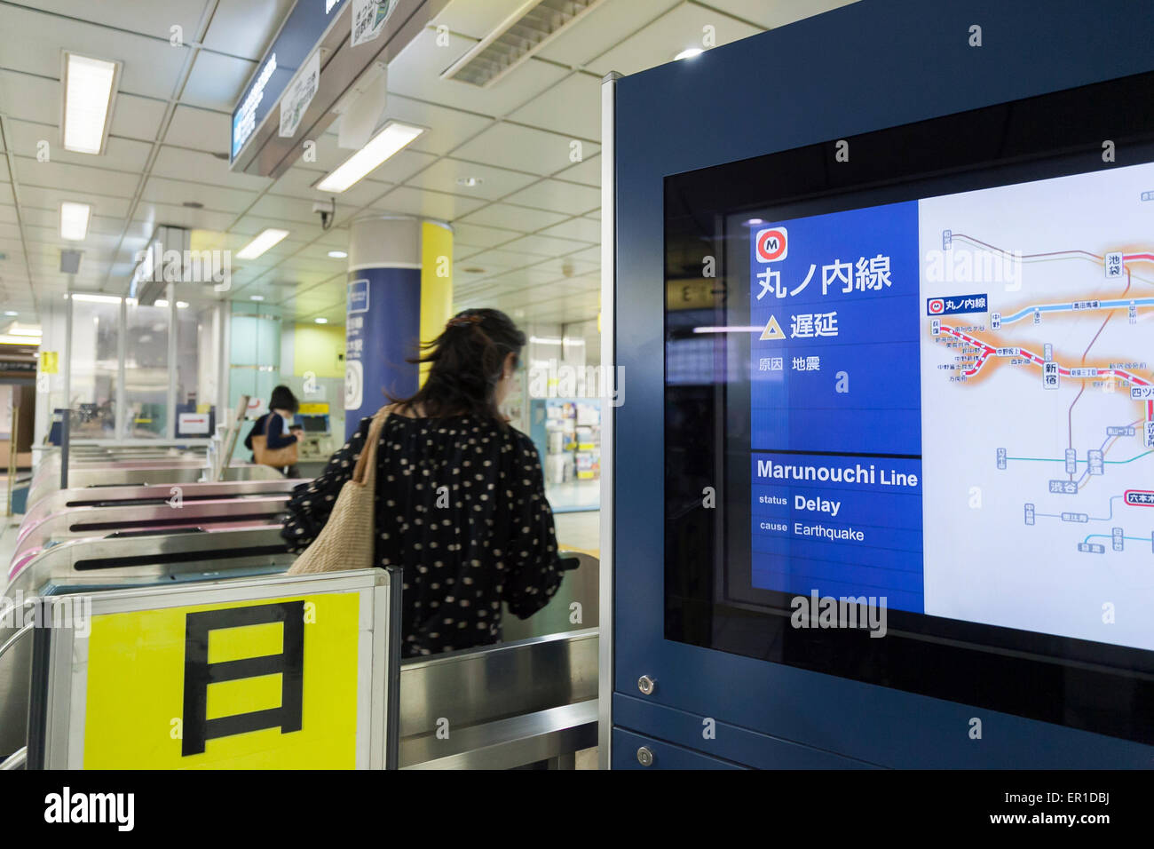 A Tokyo Metro screen announces various train lines are delayed after an ...