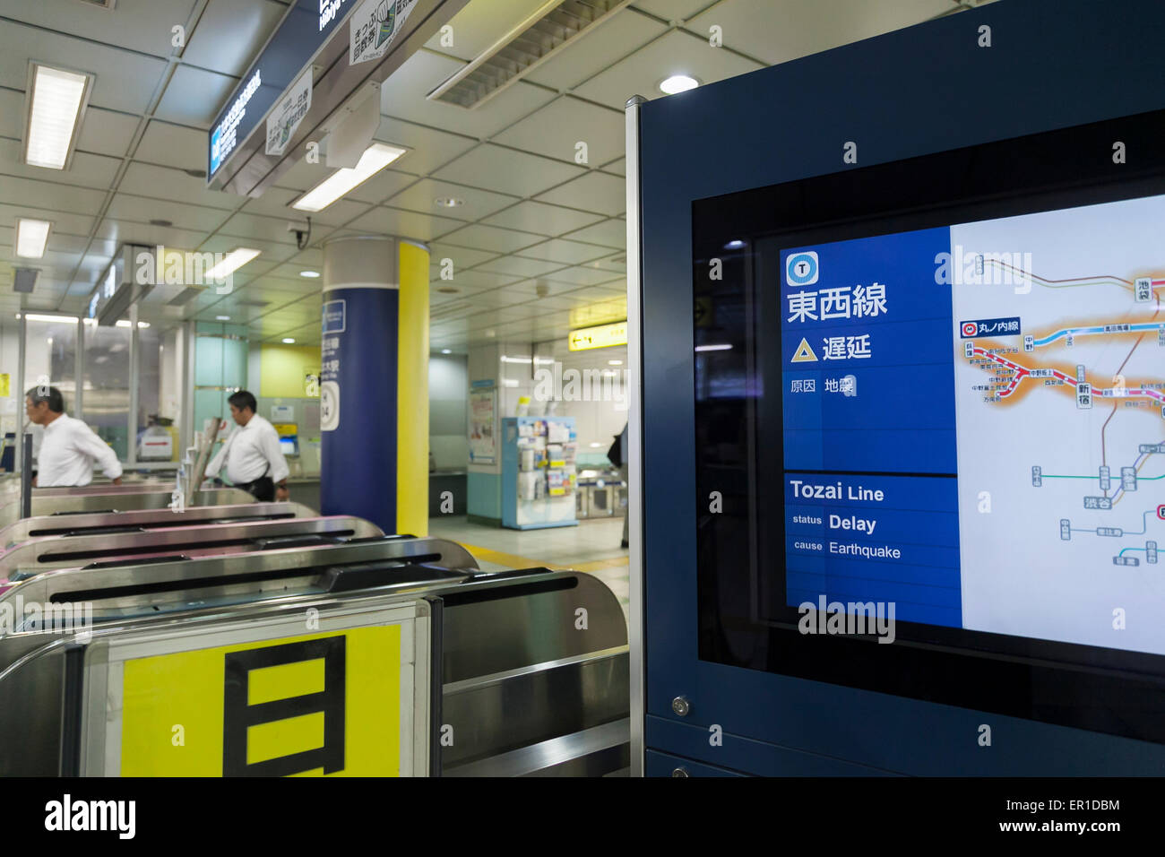 A Tokyo Metro screen announces various train lines are delayed after an ...