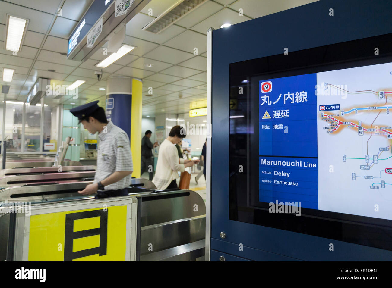 A Tokyo Metro screen announces various train lines are delayed after an ...