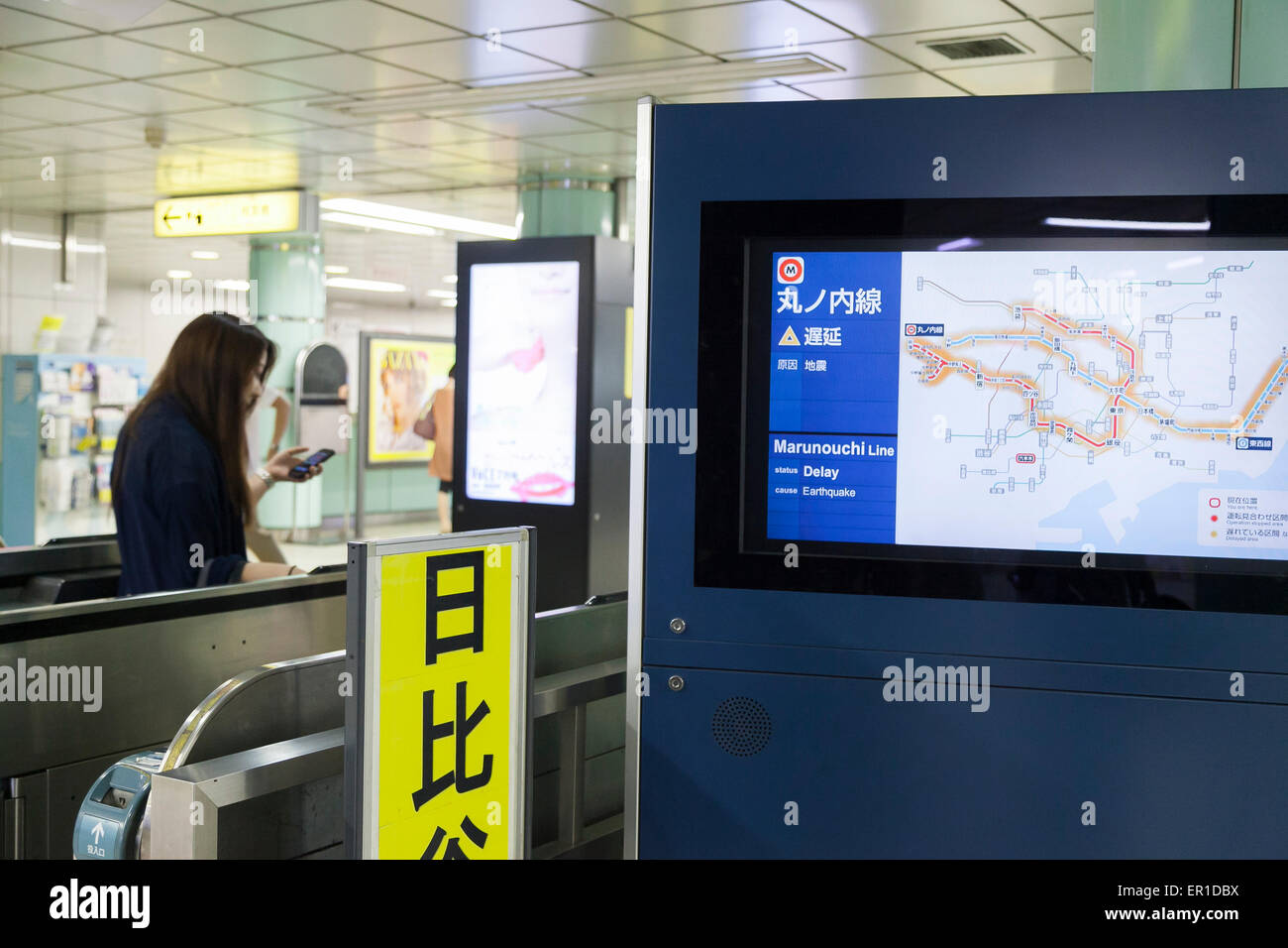 A Tokyo Metro screen announces various train lines are delayed after an ...