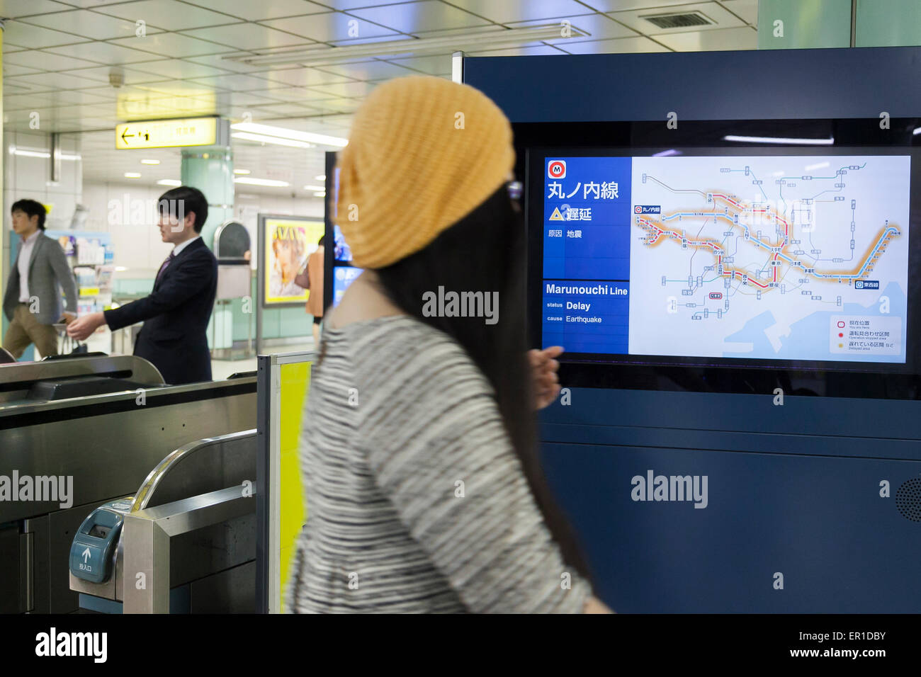 A Tokyo Metro screen announces various train lines are delayed after an ...