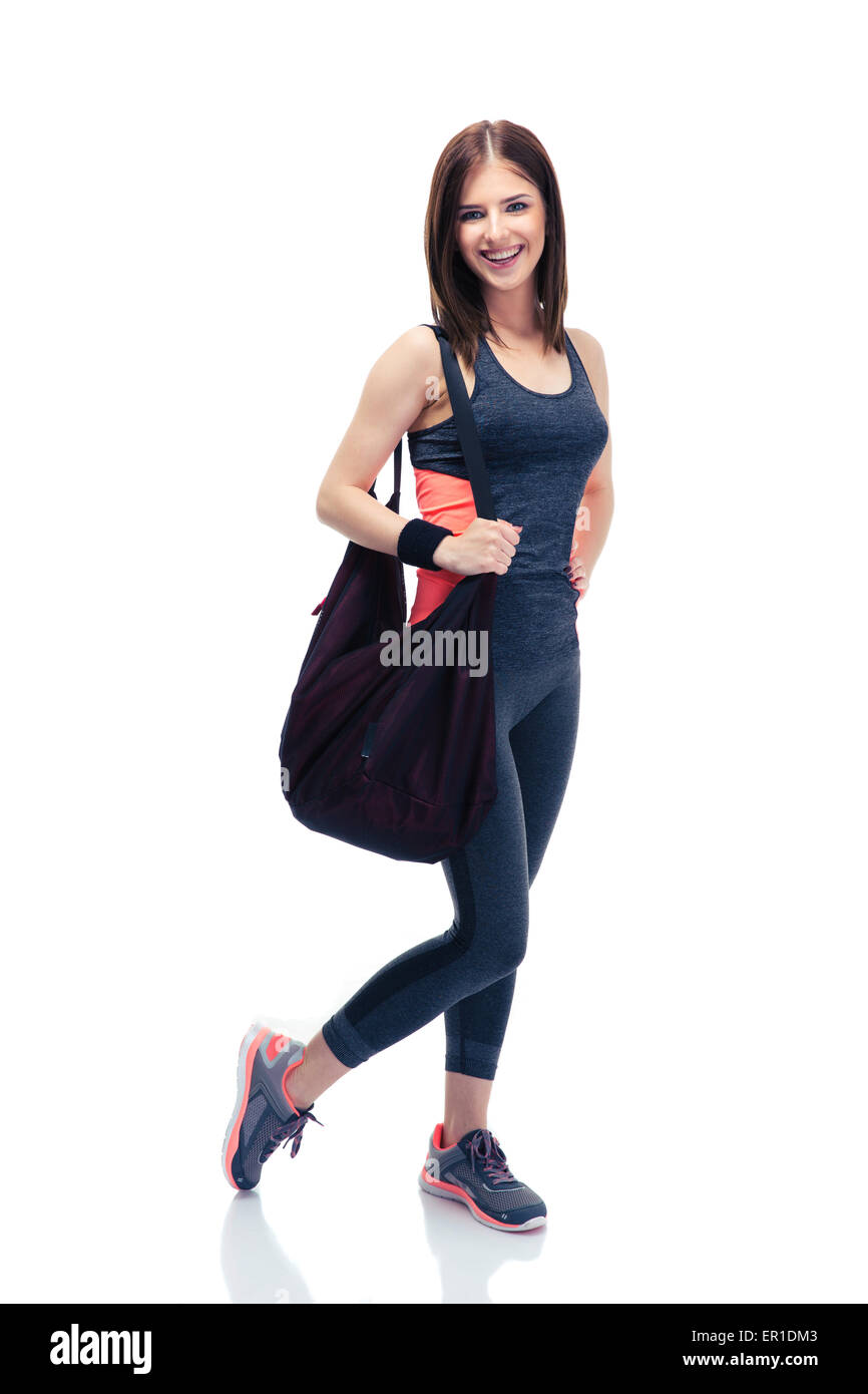 Full length portrait of a cheerful fitness woman standing with bag ...