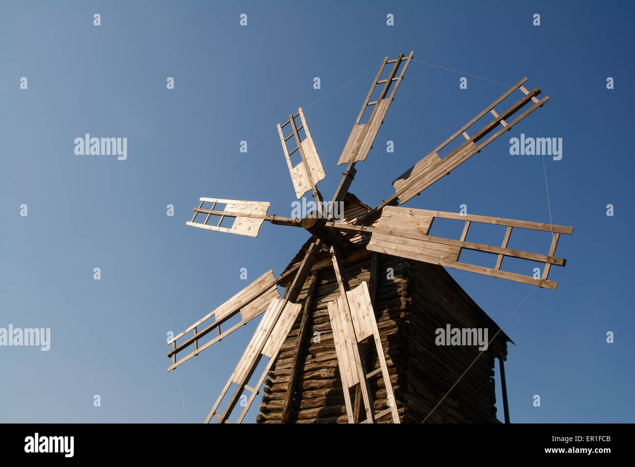 Old wooden windmill against the blue sky Stock Photo - Alamy