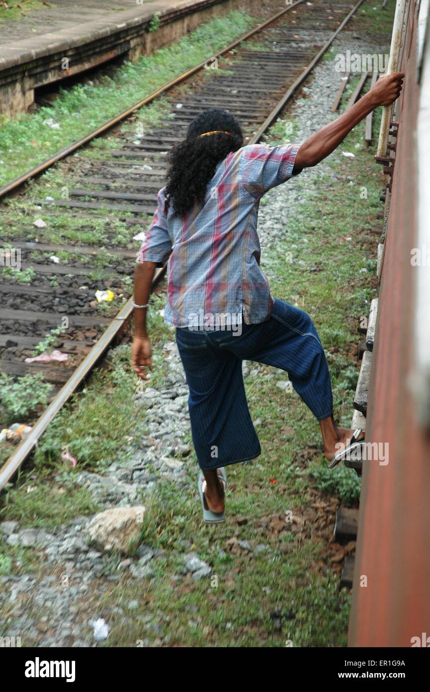 Sri Lanka, a man jumping down from a train still in motion Stock Photo ...