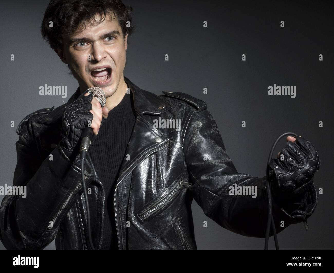 Rock singer screaming on the microphone. 21st Feb, 2014. © Igor ...