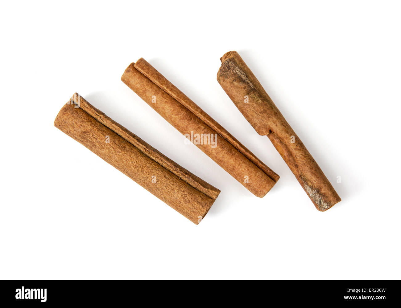 Three raw cinnamon isolated on the white background Stock Photo - Alamy