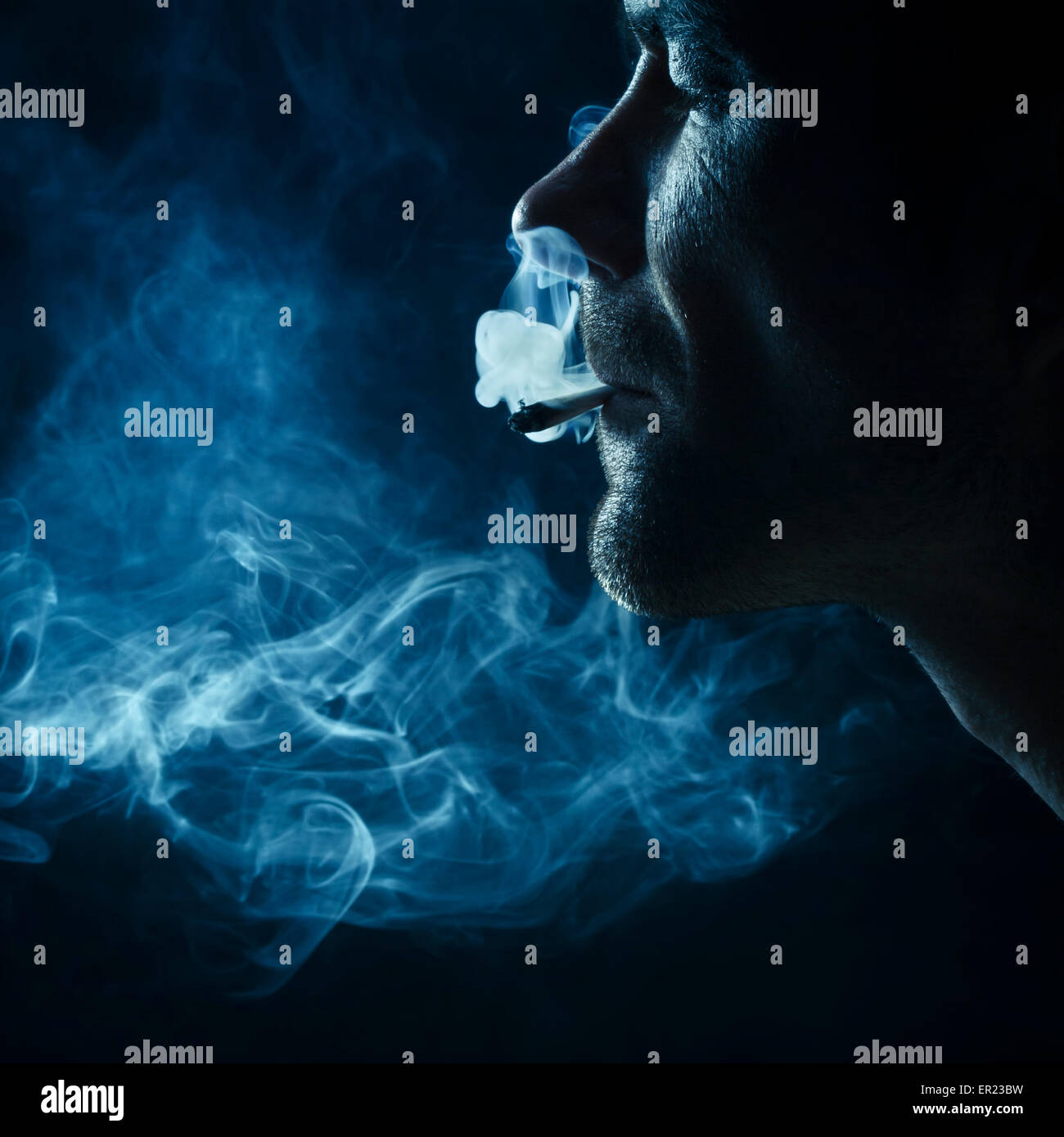 man 40 years smoking back-lit Stock Photo - Alamy