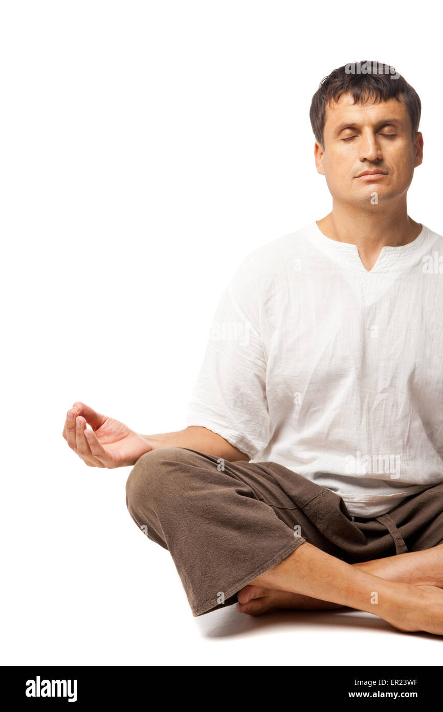 Peaceful man doing yoga and meditating - isolated over a white ...