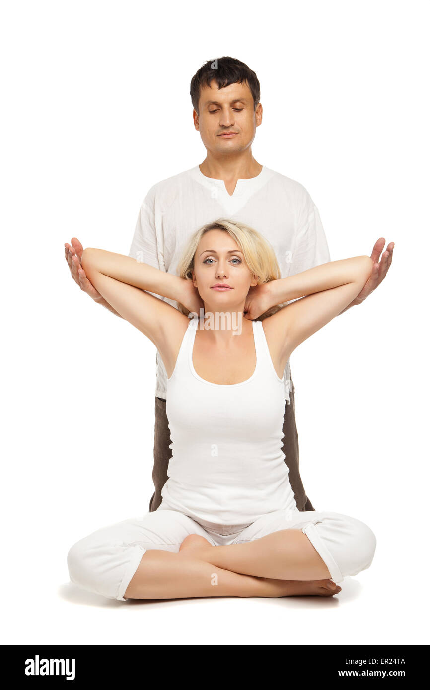 Young female sitting and receiving traditional thai arm stretching massage by therapist ...