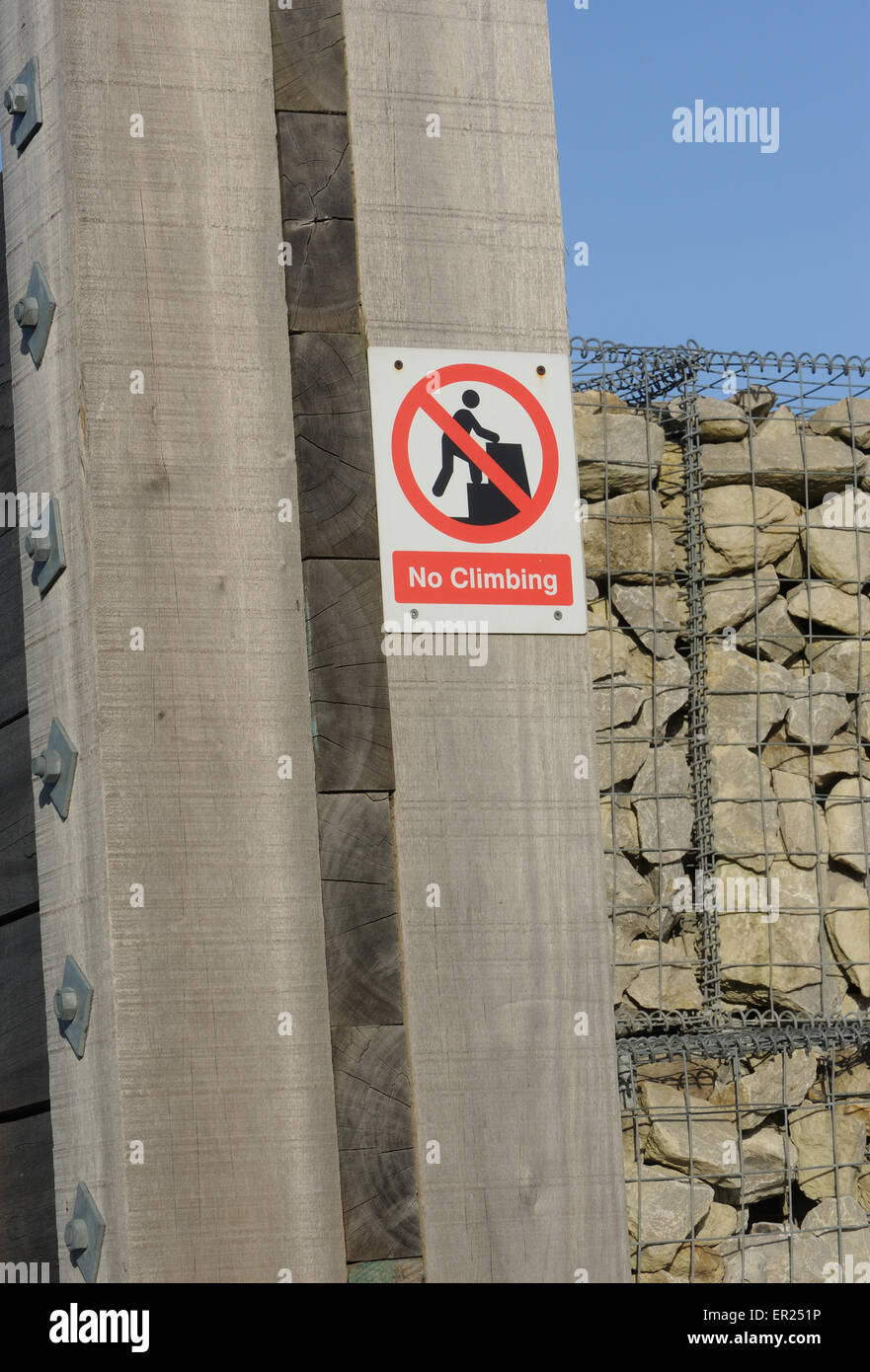 No climbing sign on gabion and timber sea defences. Whitstable, Kent ...