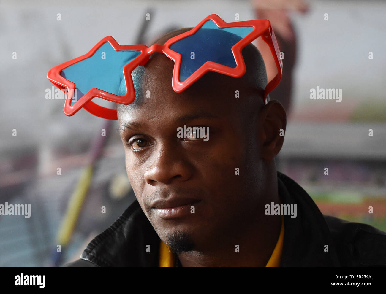Jamaican sprinter Asafa Powell poses with funny glasses for media prior ...
