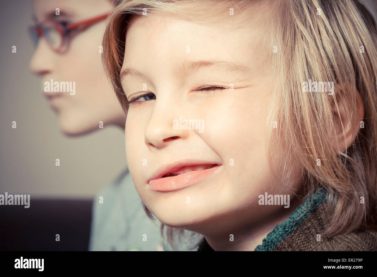 boys children winking 6 and 8 years Stock Photo - Alamy