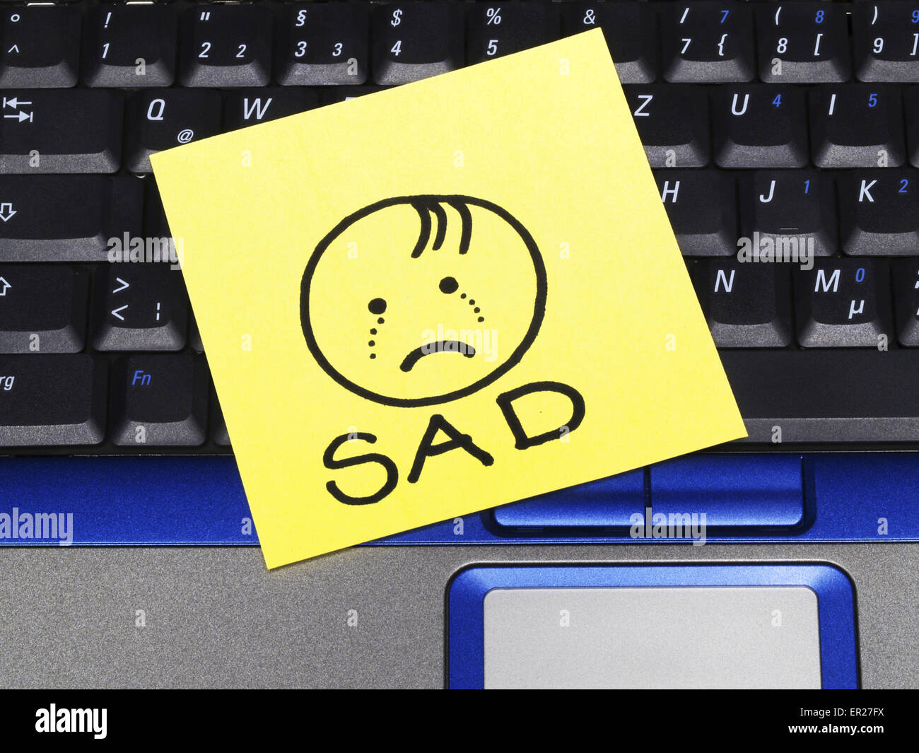 Memo note on notebook, smiley sad drawing Stock Photo - Alamy