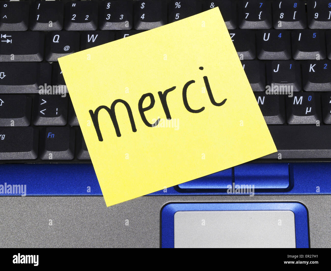 Memo note on notebook, merci thanks Stock Photo - Alamy
