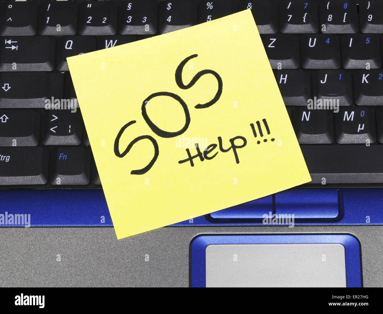 Memo note on notebook, SOS help Stock Photo - Alamy