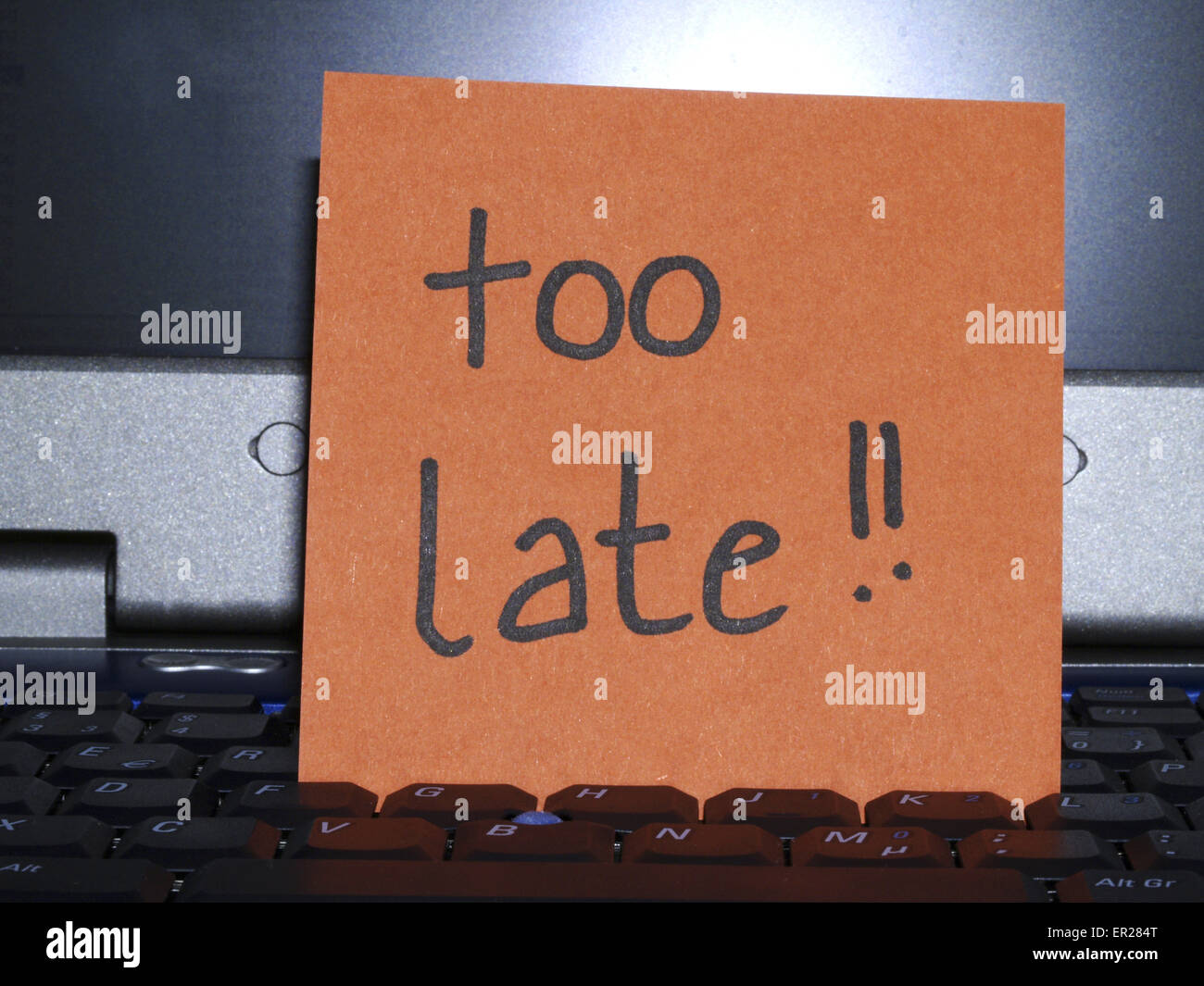 Memo note on notebook, too late Stock Photo - Alamy