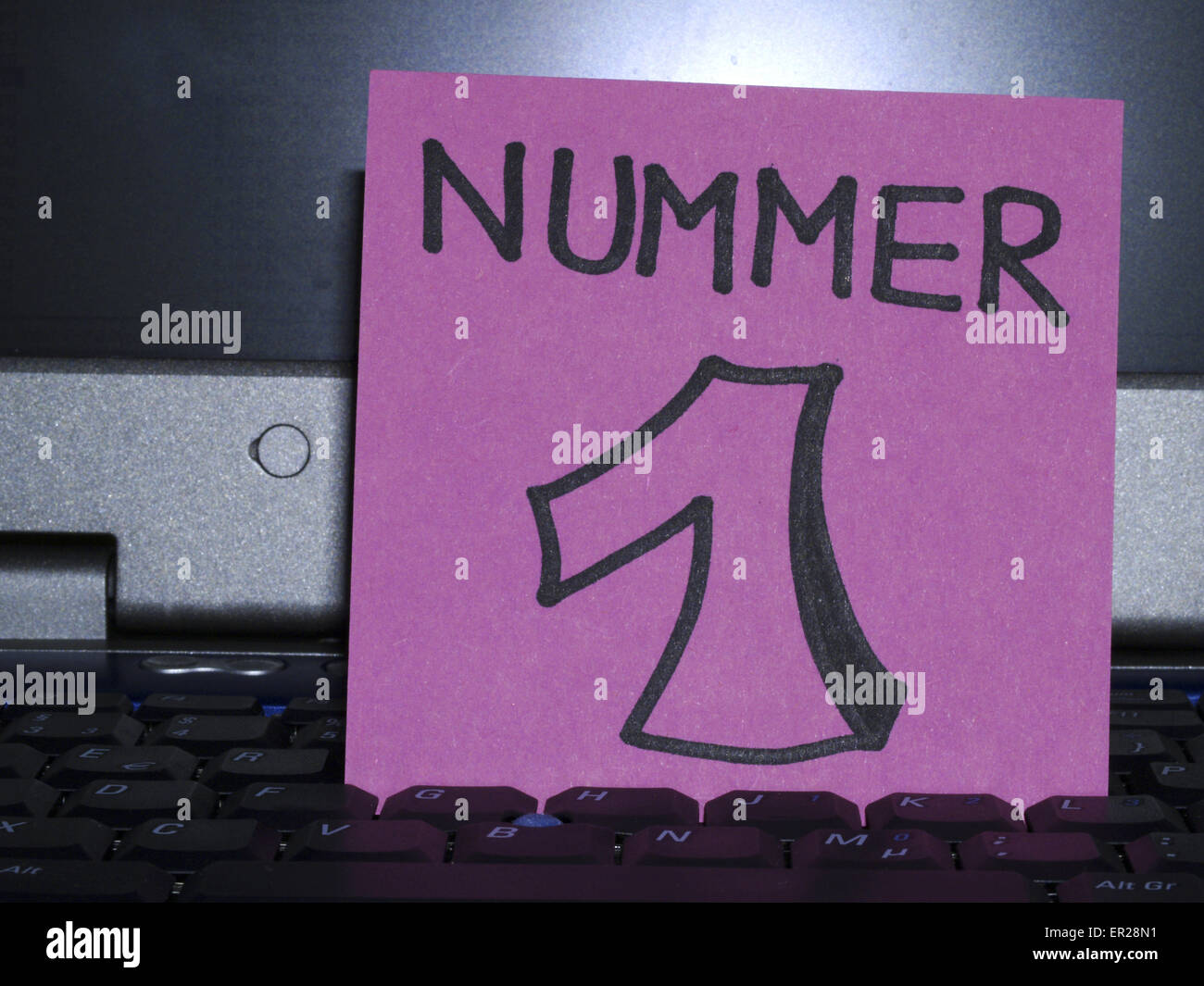 Memo note on notebook, nummer number one Stock Photo - Alamy
