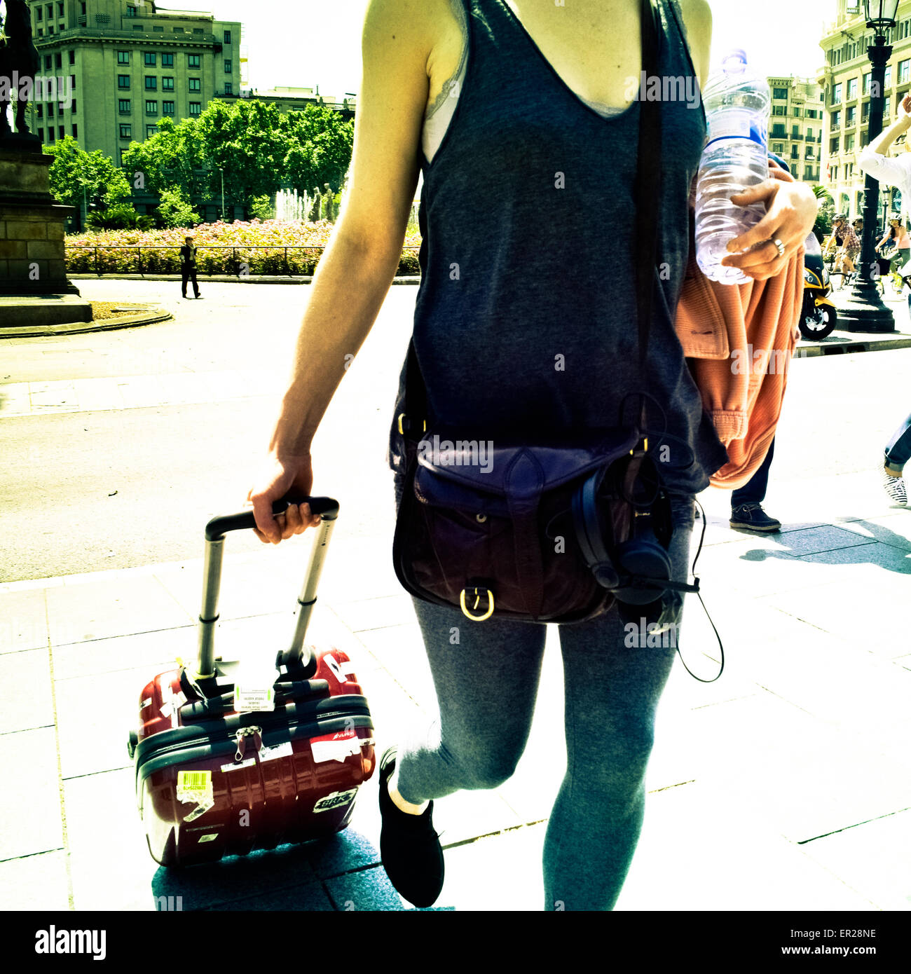 Woman walking with a wheeled suitcase. Barcelona, Catalonia, Spain ...
