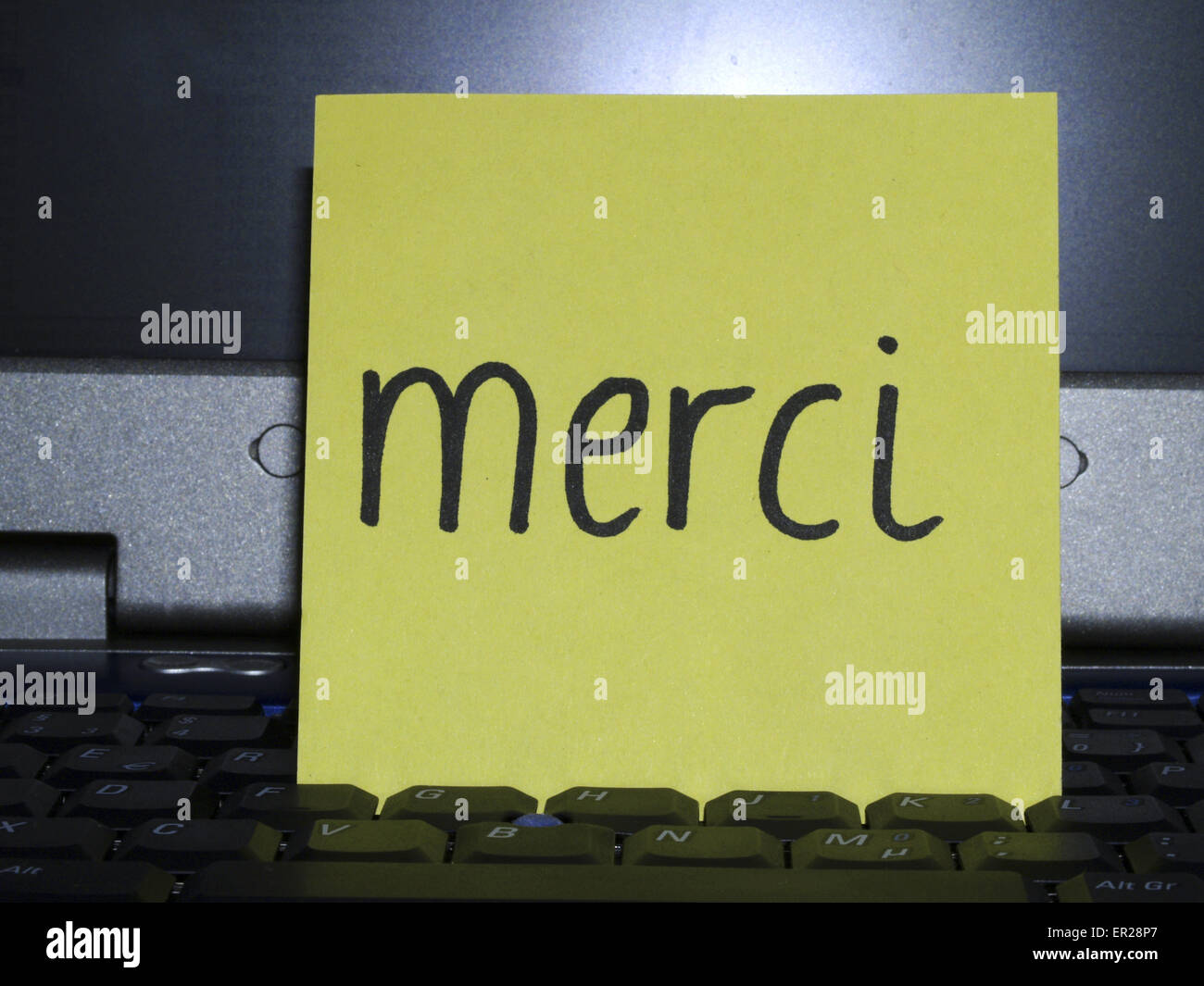 Memo note on notebook, merci, thanks Stock Photo - Alamy