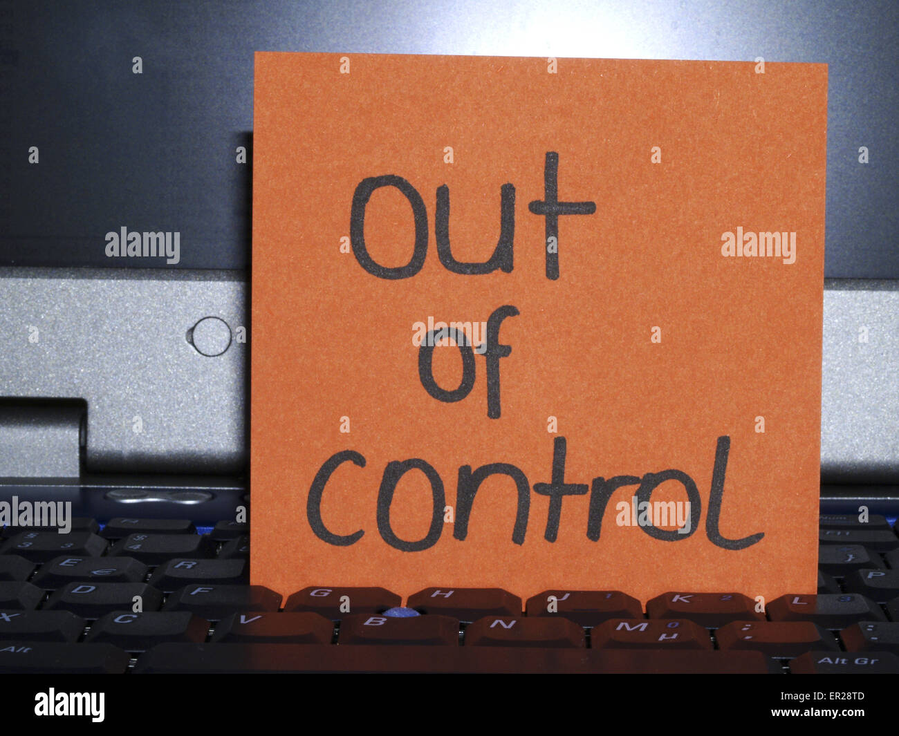 Memo note on notebook, out of control Stock Photo - Alamy