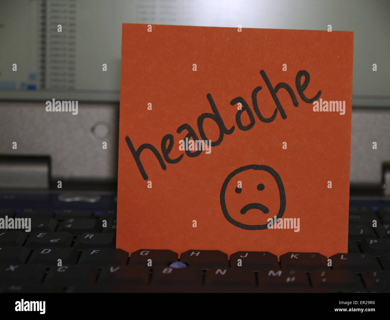 Memo note on notebook, headache Stock Photo - Alamy