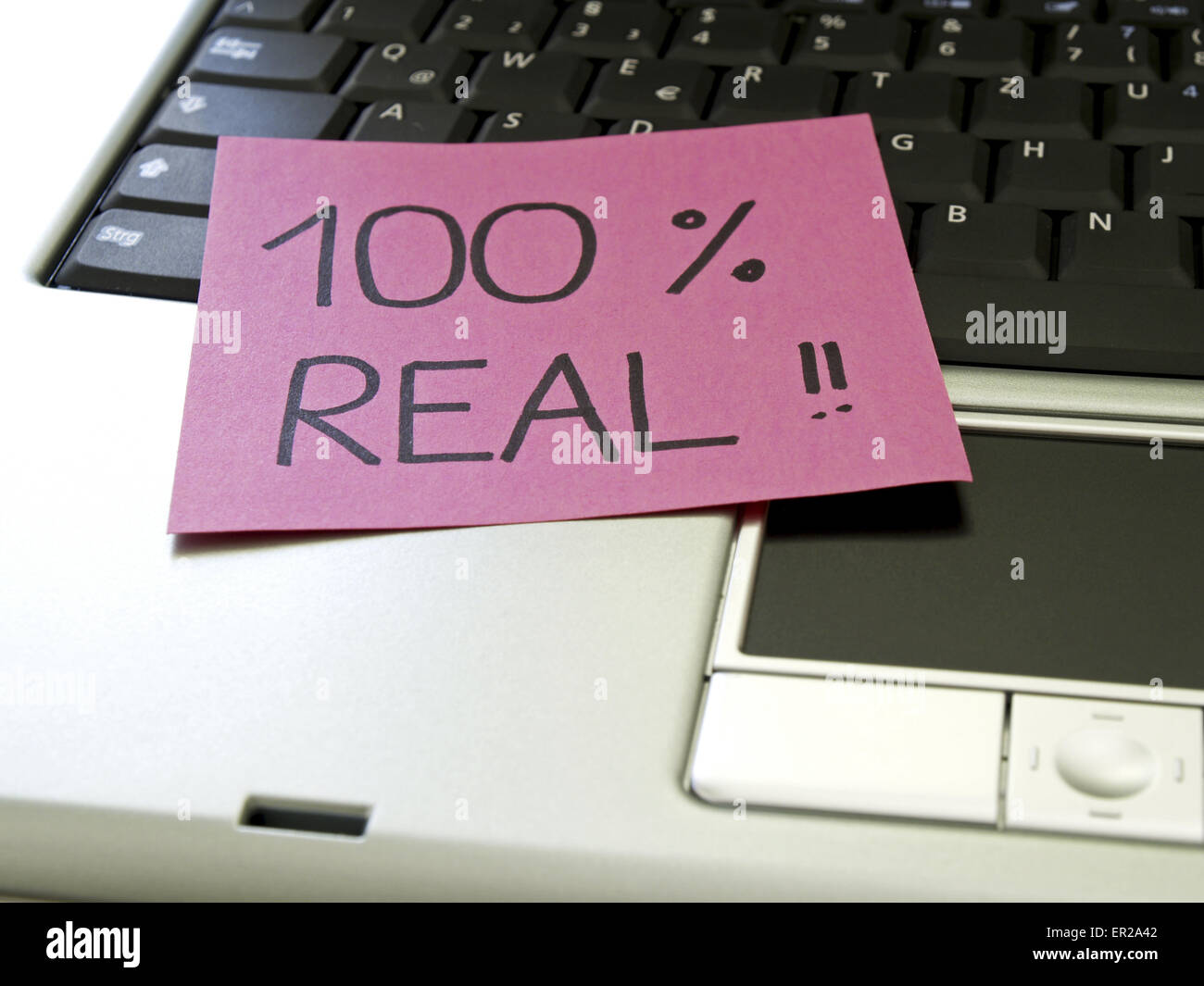 Memo note on notebook, 100 percent real Stock Photo - Alamy