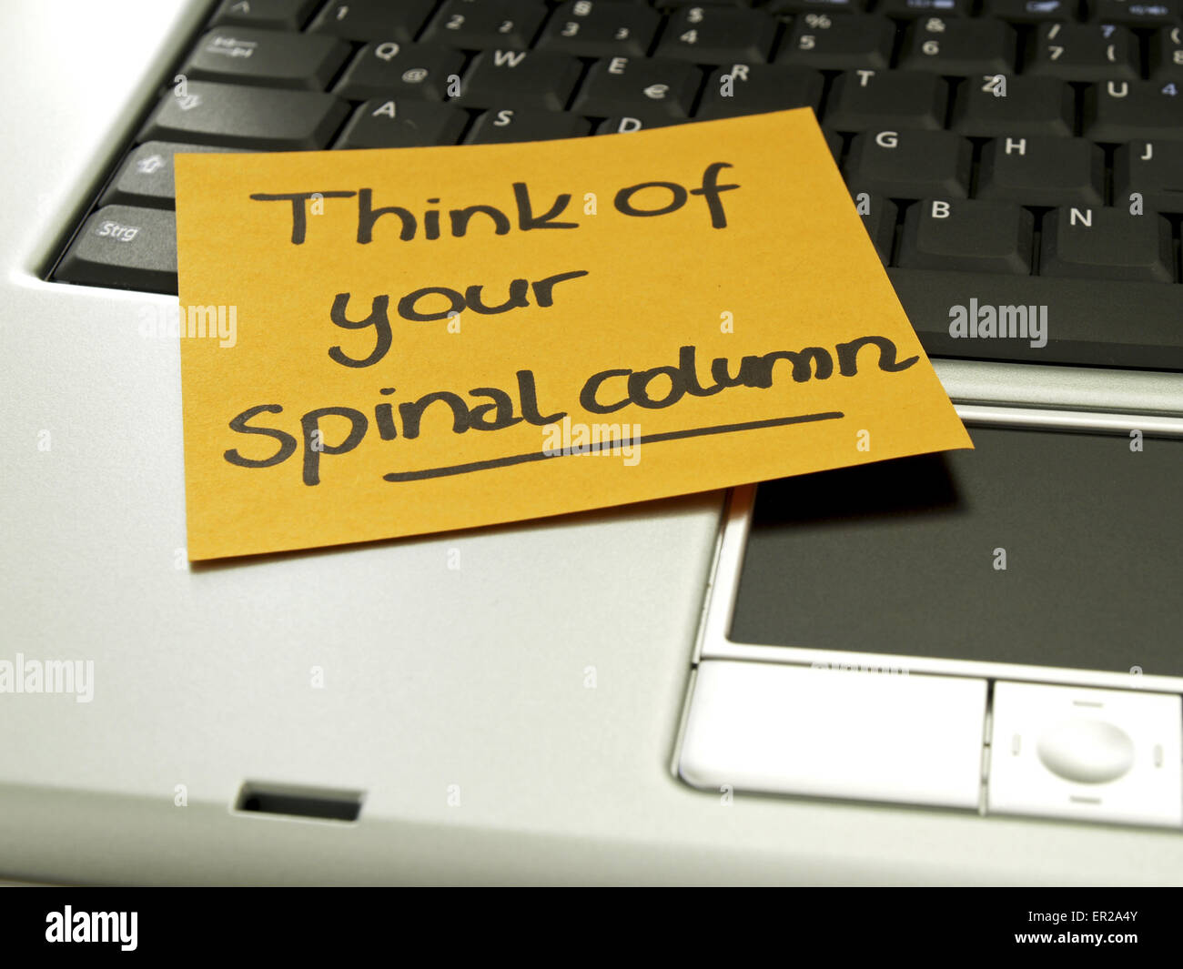 Memo note on notebook, think of your spinal column Stock Photo - Alamy