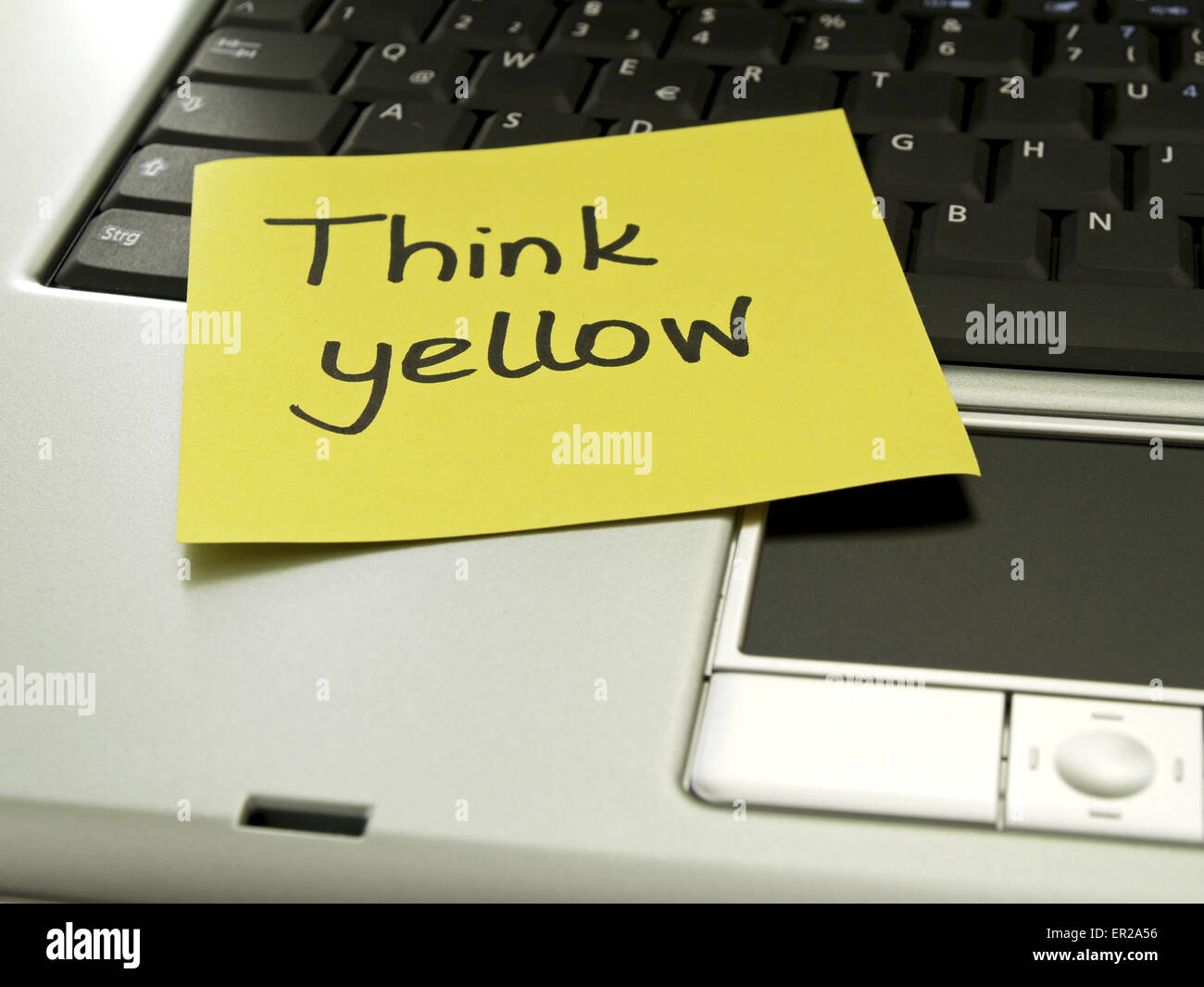 Memo note on notebook, think yellow Stock Photo - Alamy