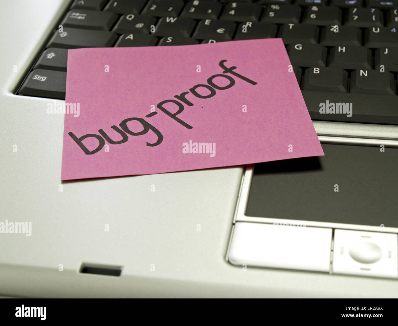 Memo note on notebook, bug-proof Stock Photo - Alamy