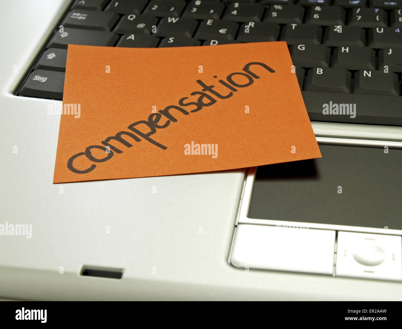 Memo note on notebook, compensation Stock Photo - Alamy