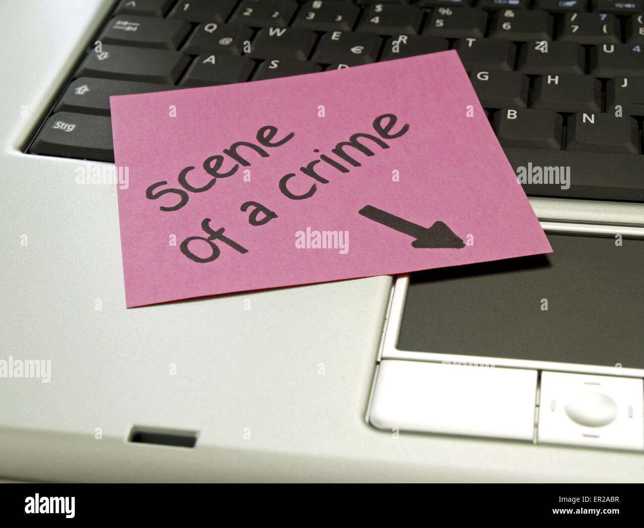 Memo note on notebook, scene of a crime arrow pointing towards touch ...