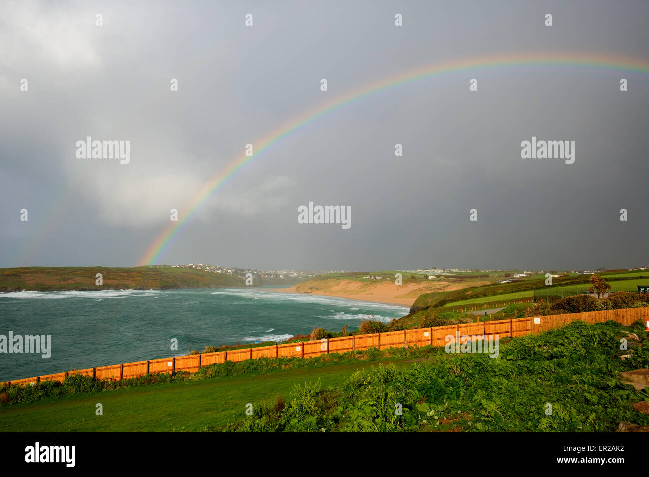Colourful rainbow at Crantock bay in Cornwall England UK with grey sky ...