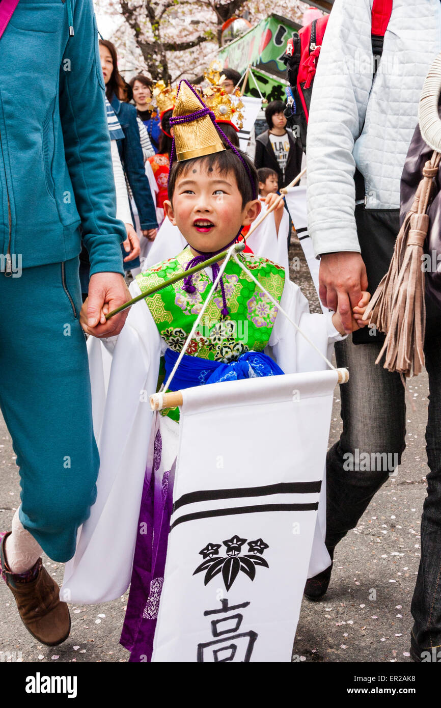 Row of Japanese children, boys, walking in the springtime Genji parade ...