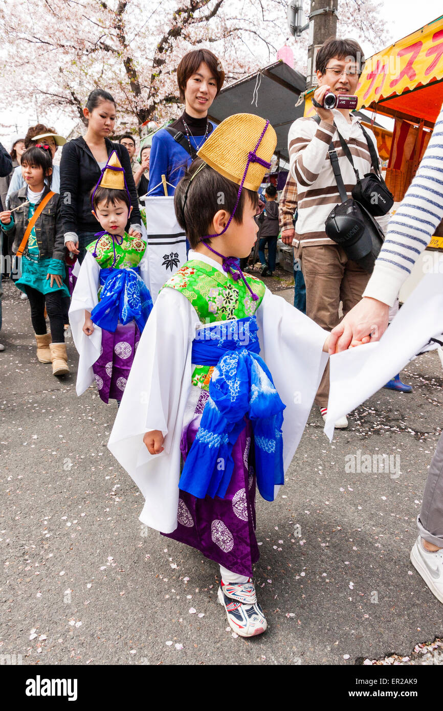Row of Japanese children, boys, walking in the springtime Genji parade ...