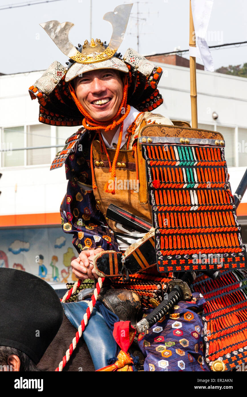 Japanese man dressed in full samurai armour on horseback smiling at ...