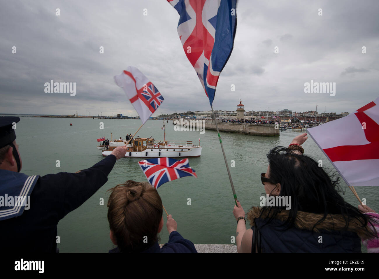 Spectators wave flags and cheer as they welcome the returning Dunkirk ...
