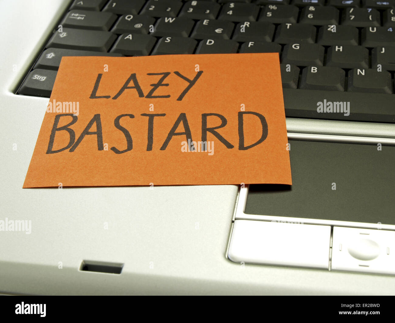 Memo note on notebook, lazy bastard Stock Photo - Alamy