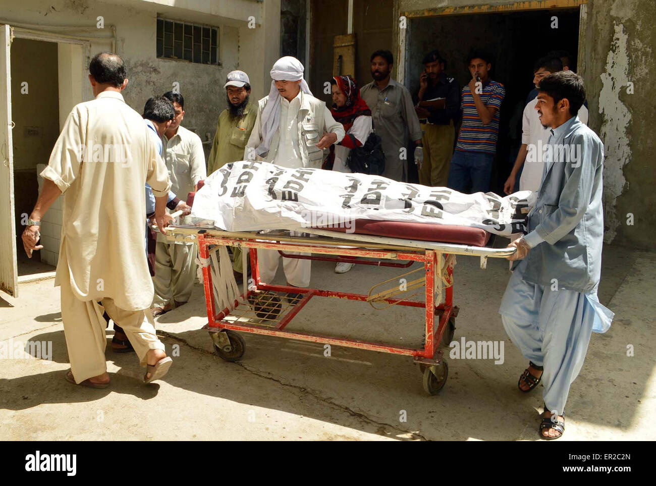 Rescue officials busy in shifting of dead body of a man assassinated by ...