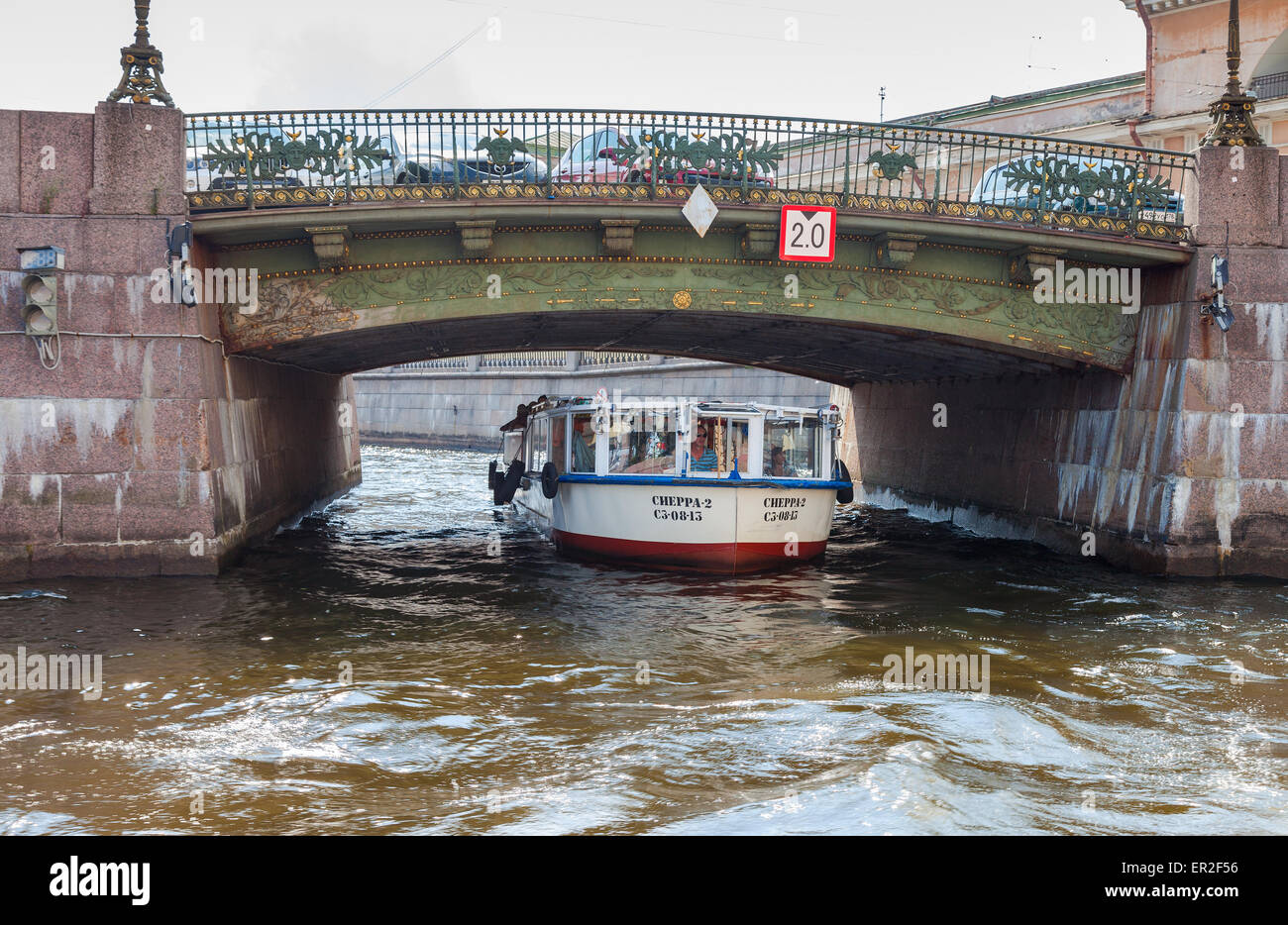 Tourist boat goes through the channel on a sunny day in the historic ...
